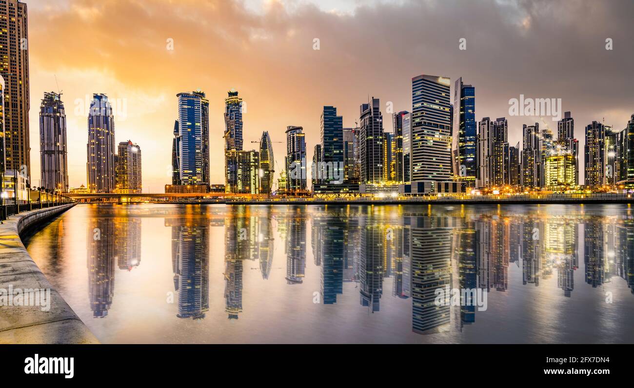 Stunning view of the illuminated Dubai skyline during a dramatic sunset ...