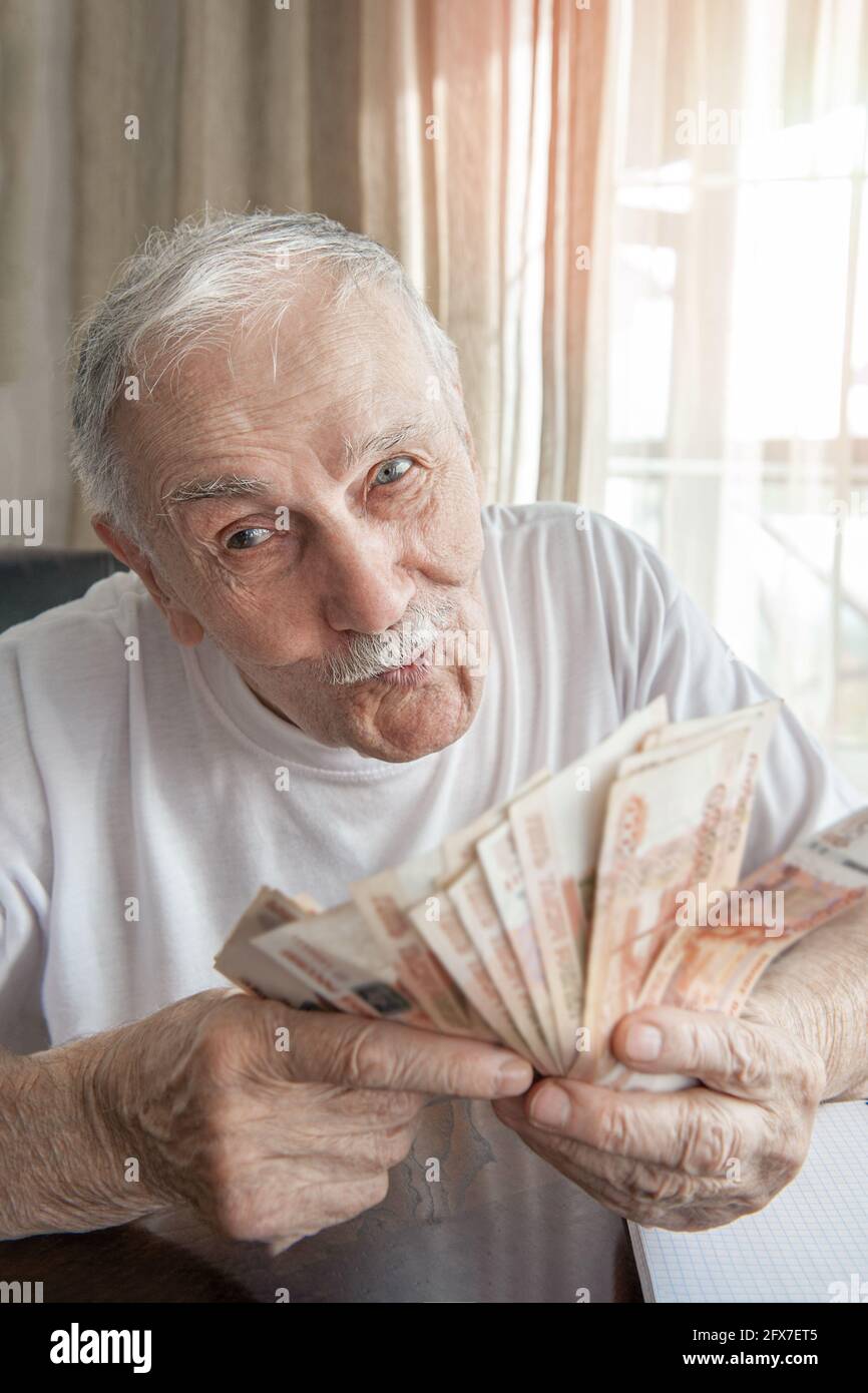 Mature businessman counting cash money hi-res stock photography and ...