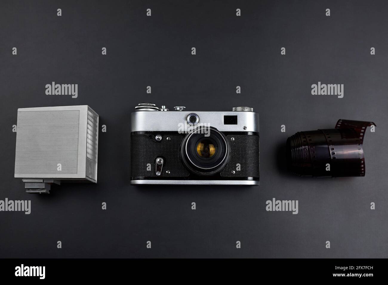 Photographic set, old vintage camera, flash, camera roll on a black ...