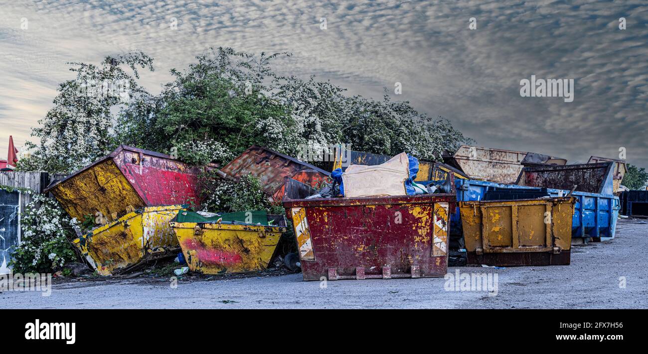 Collection of old used waste skips Stock Photo - Alamy