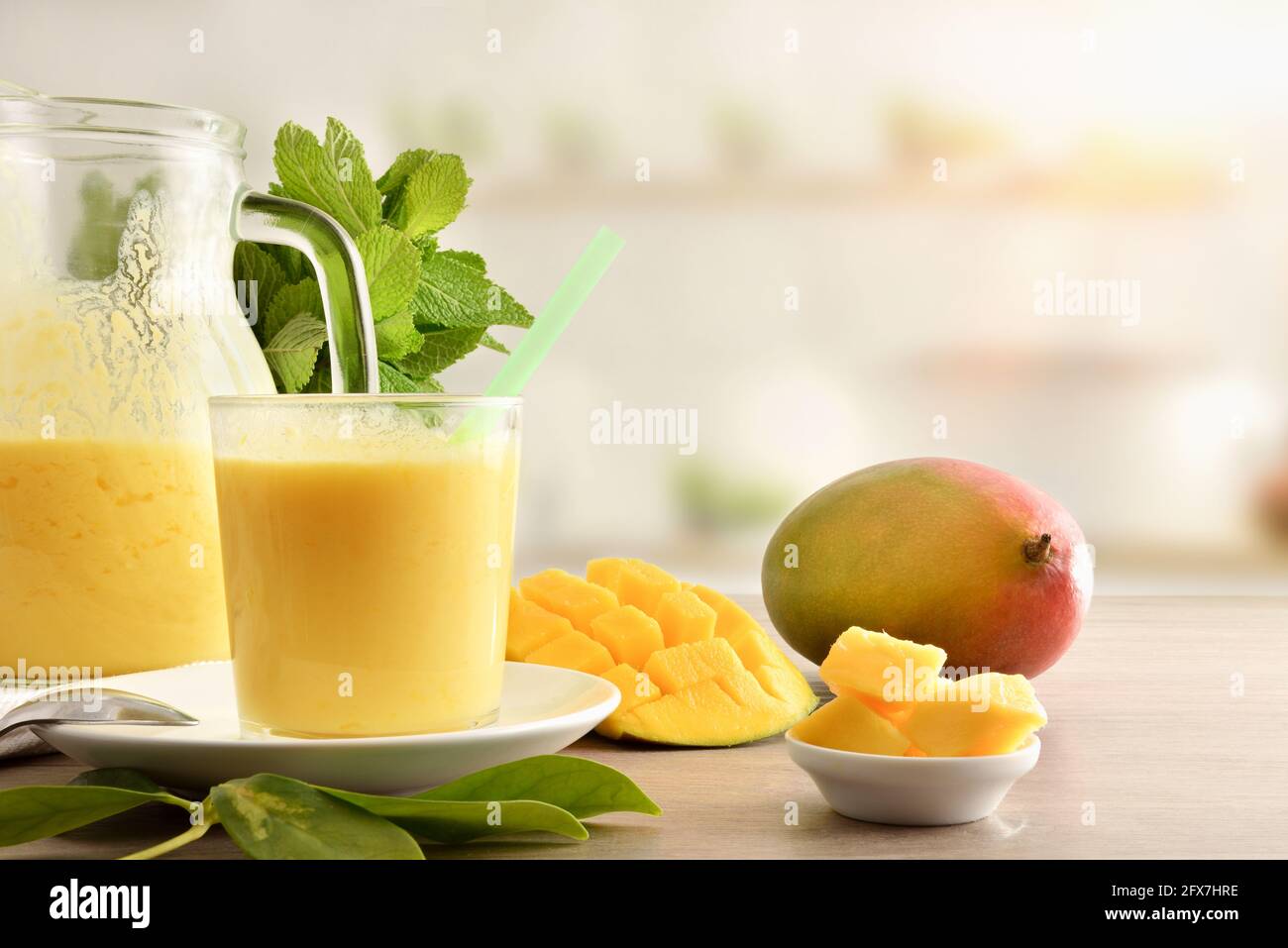 Breakfast with natural mango juice with milk on a kitchen bench with ...
