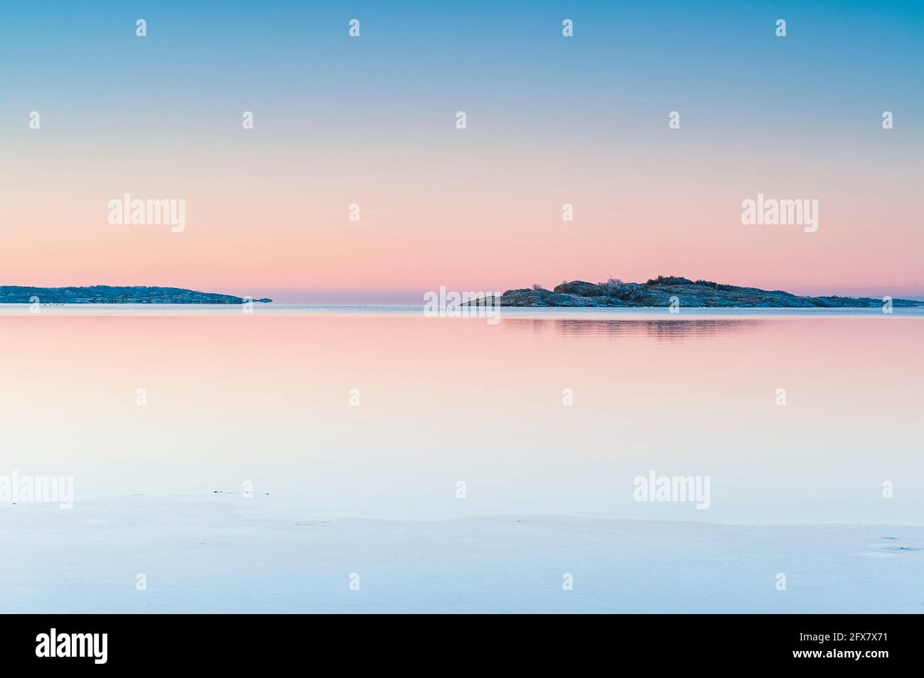 Islands at still sea during sunrise Stock Photo - Alamy