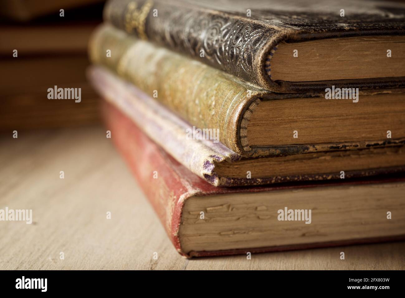 Books stacked on a table Stock Photo - Alamy