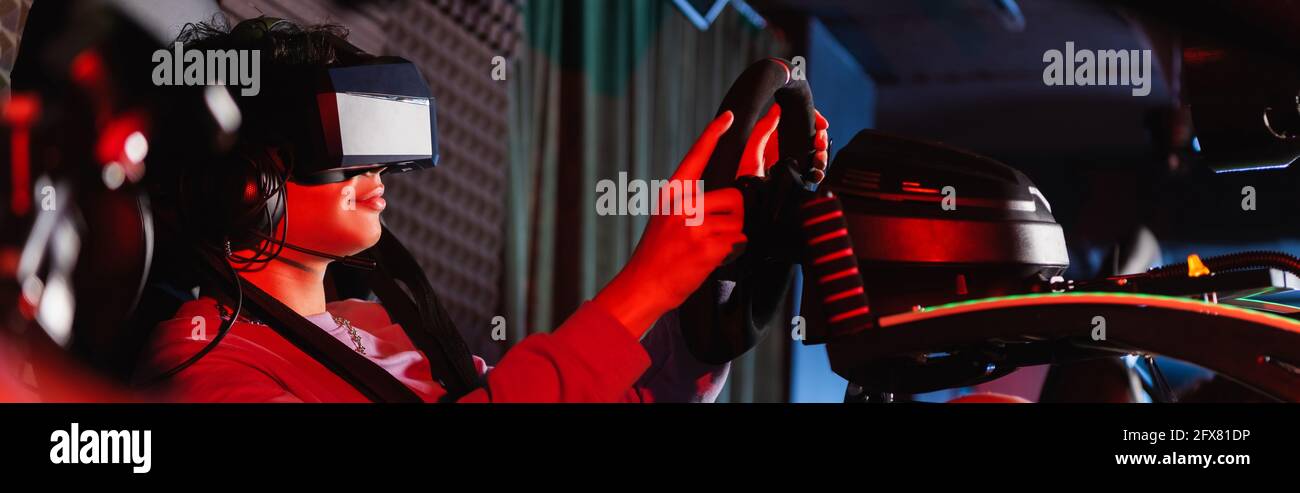 teenage boy in vr headset playing on car racing simulator, banner Stock ...