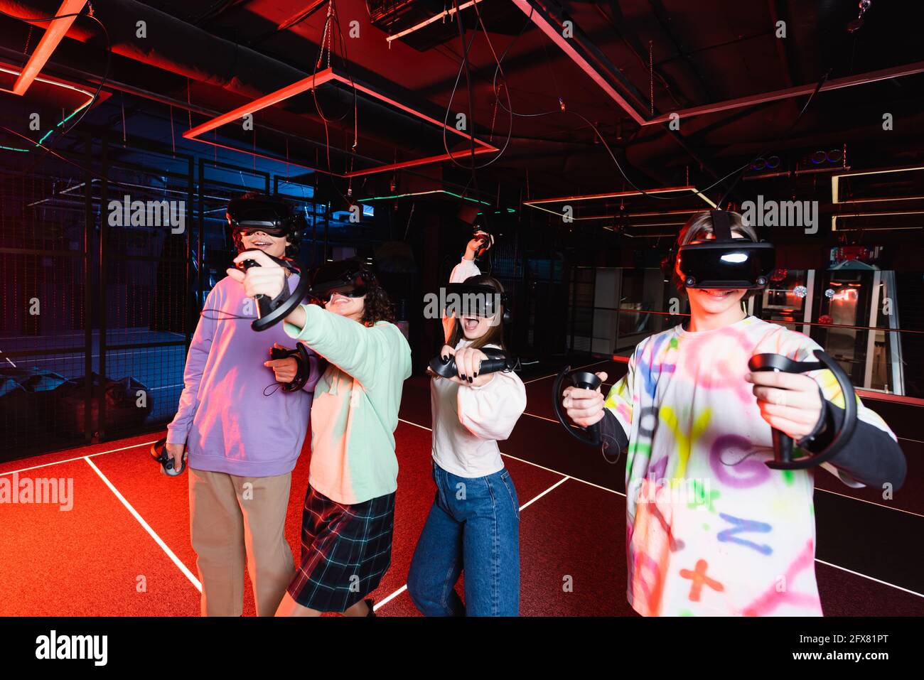 cheerful interracial teenagers having fun in vr play zone Stock Photo ...