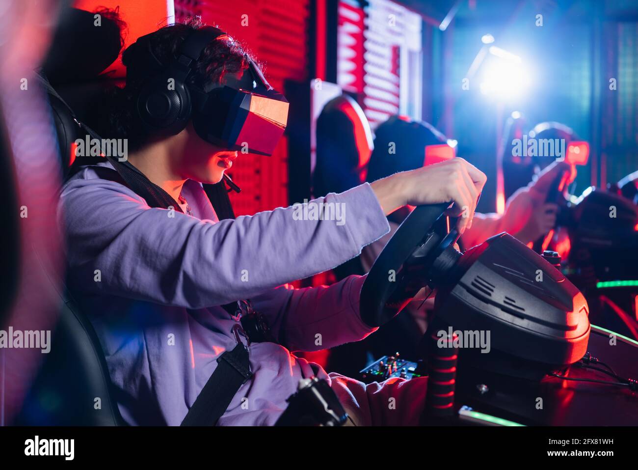 teenage boy in vr headset playing racing game on car simulator Stock ...