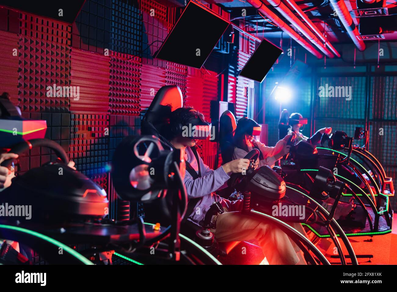 teenagers in vr headsets playing racing game in car simulators Stock ...