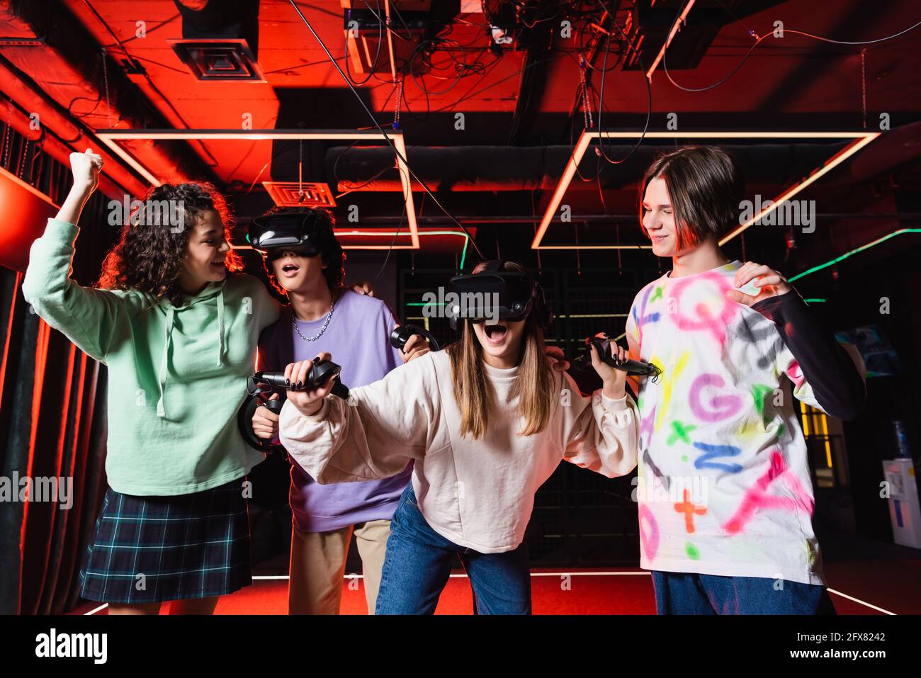african american teenage girl showing triumph gesture near amazed ...