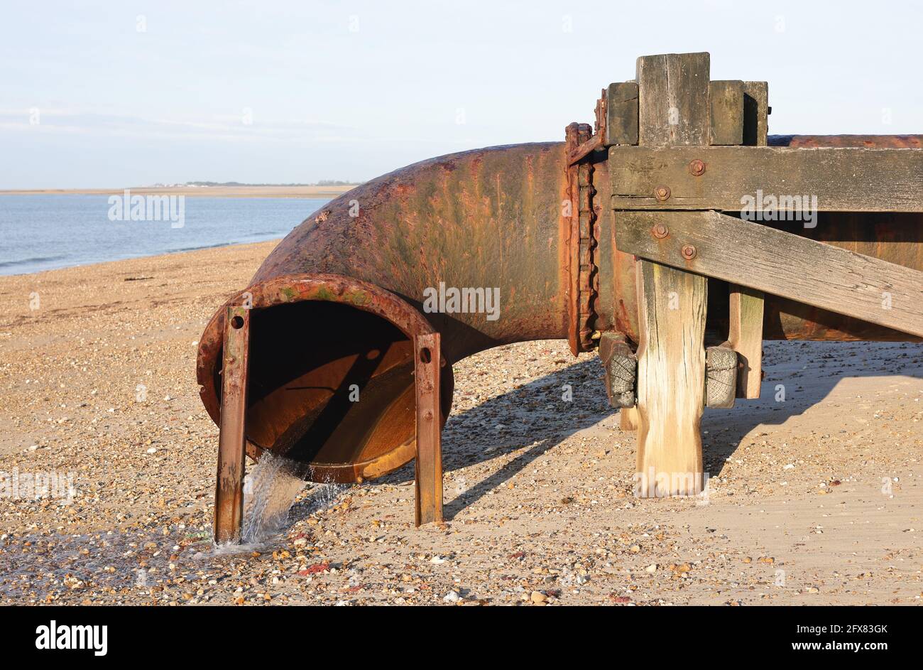 Large metal surface water outlet directing fresh water to the sea on ...