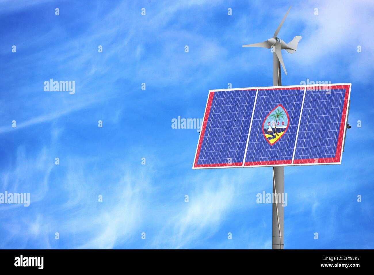 Solar panels against a blue sky with a picture of the flag of Guam ...