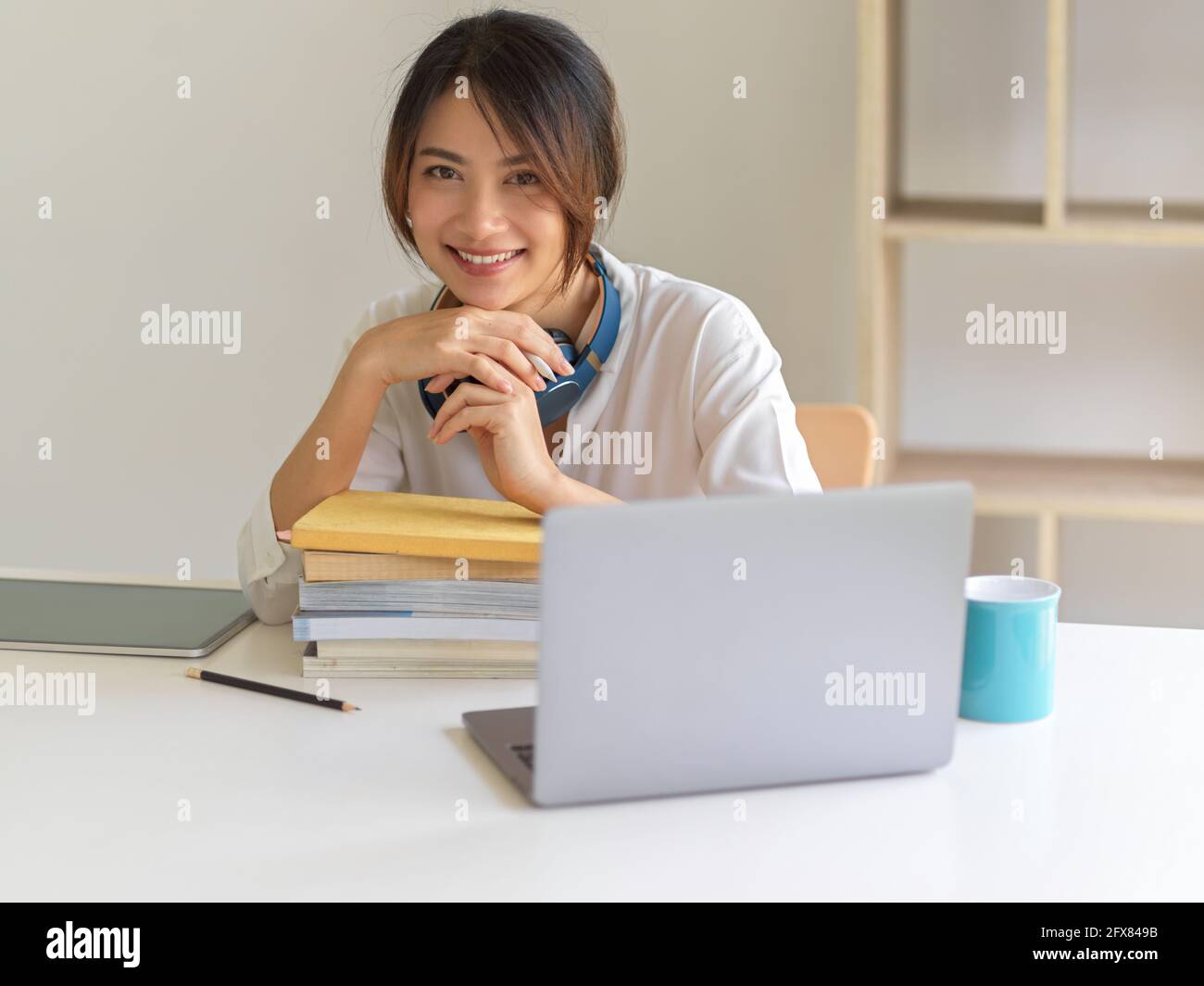 Portrait happy professor sitting desk hi-res stock photography and ...