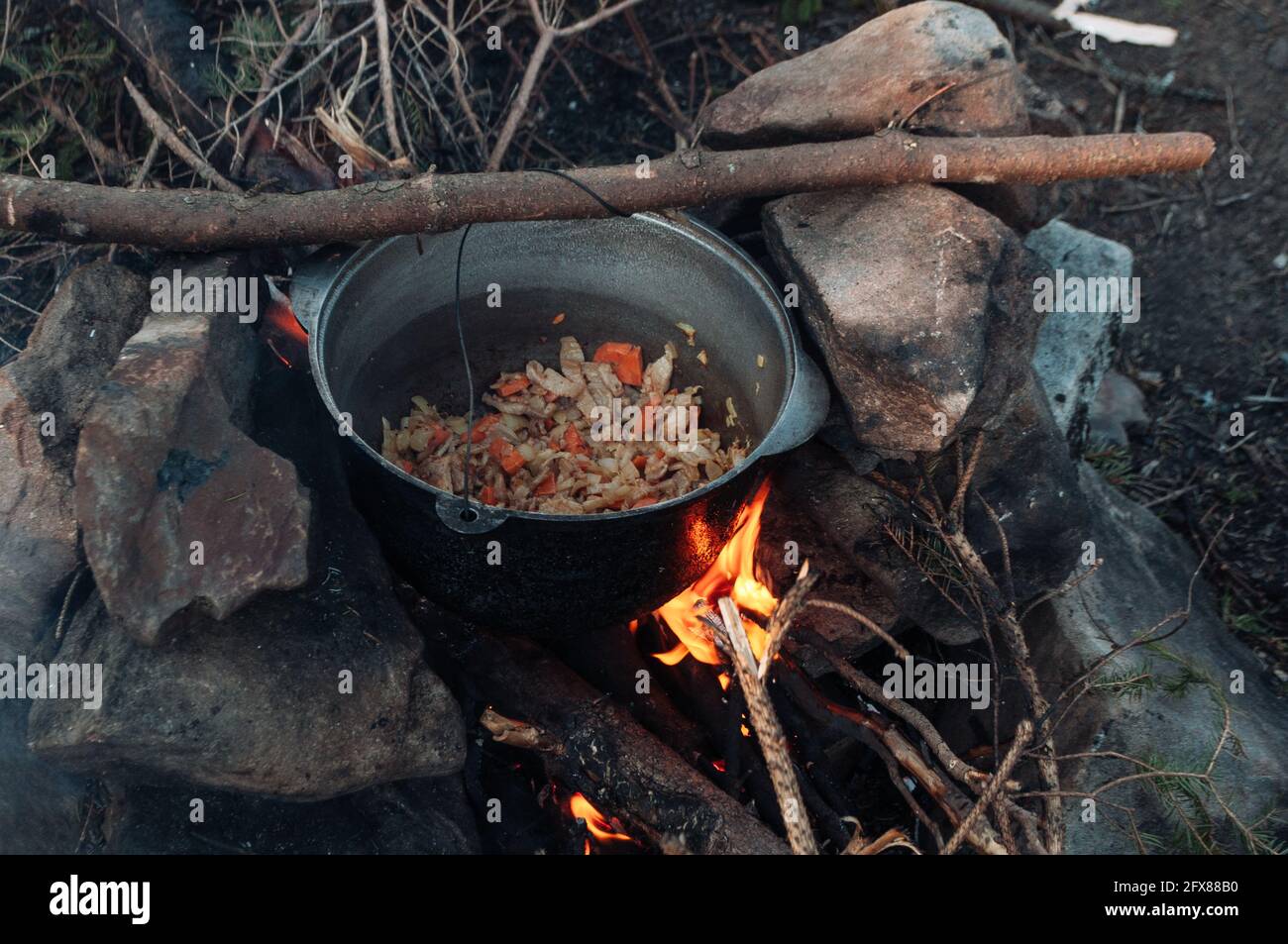 Top view of a metal cauldron with food on the campfire Stock Photo - Alamy