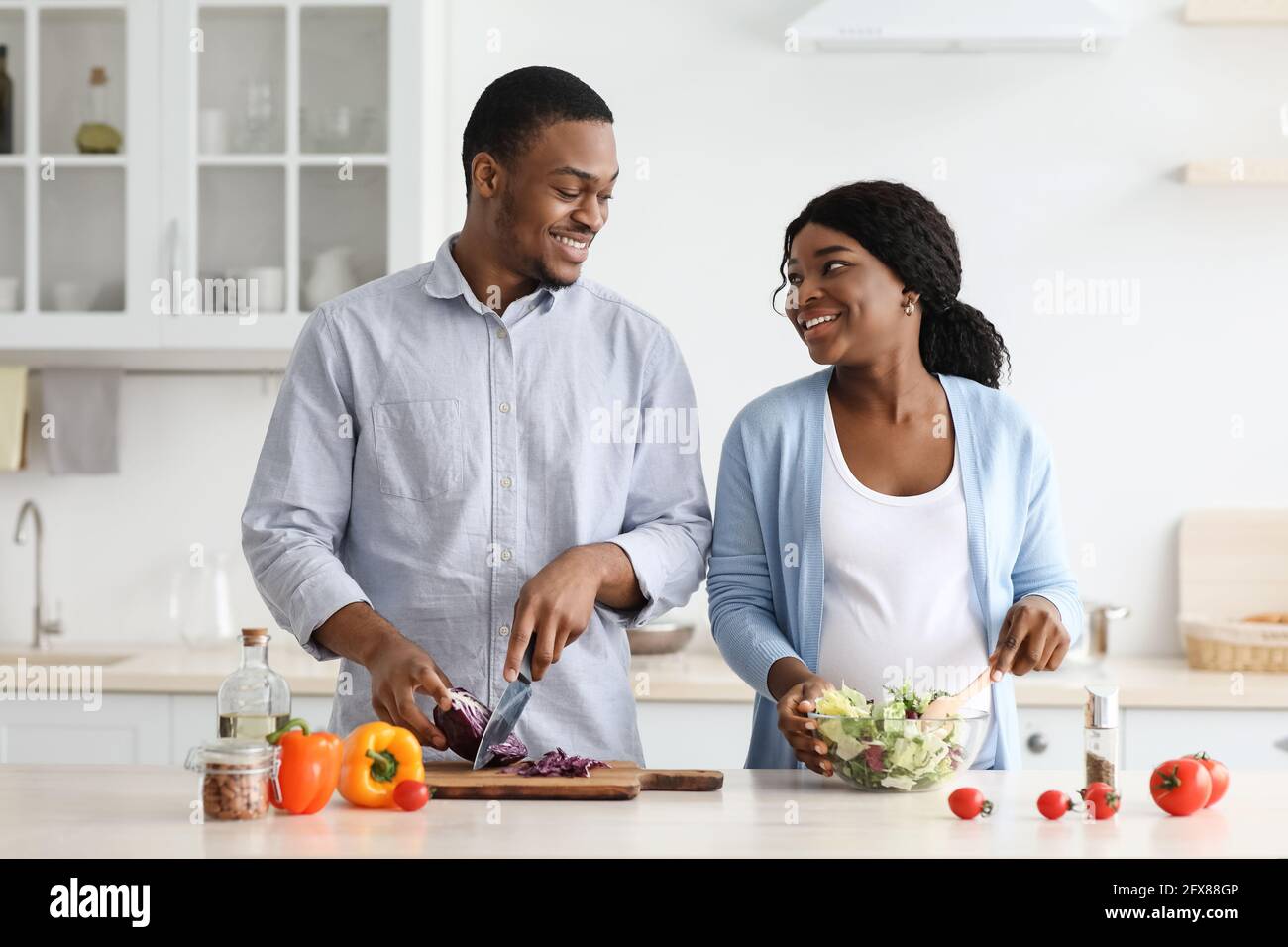 Loving expecting black couple enjoying cooking together Stock Photo - Alamy