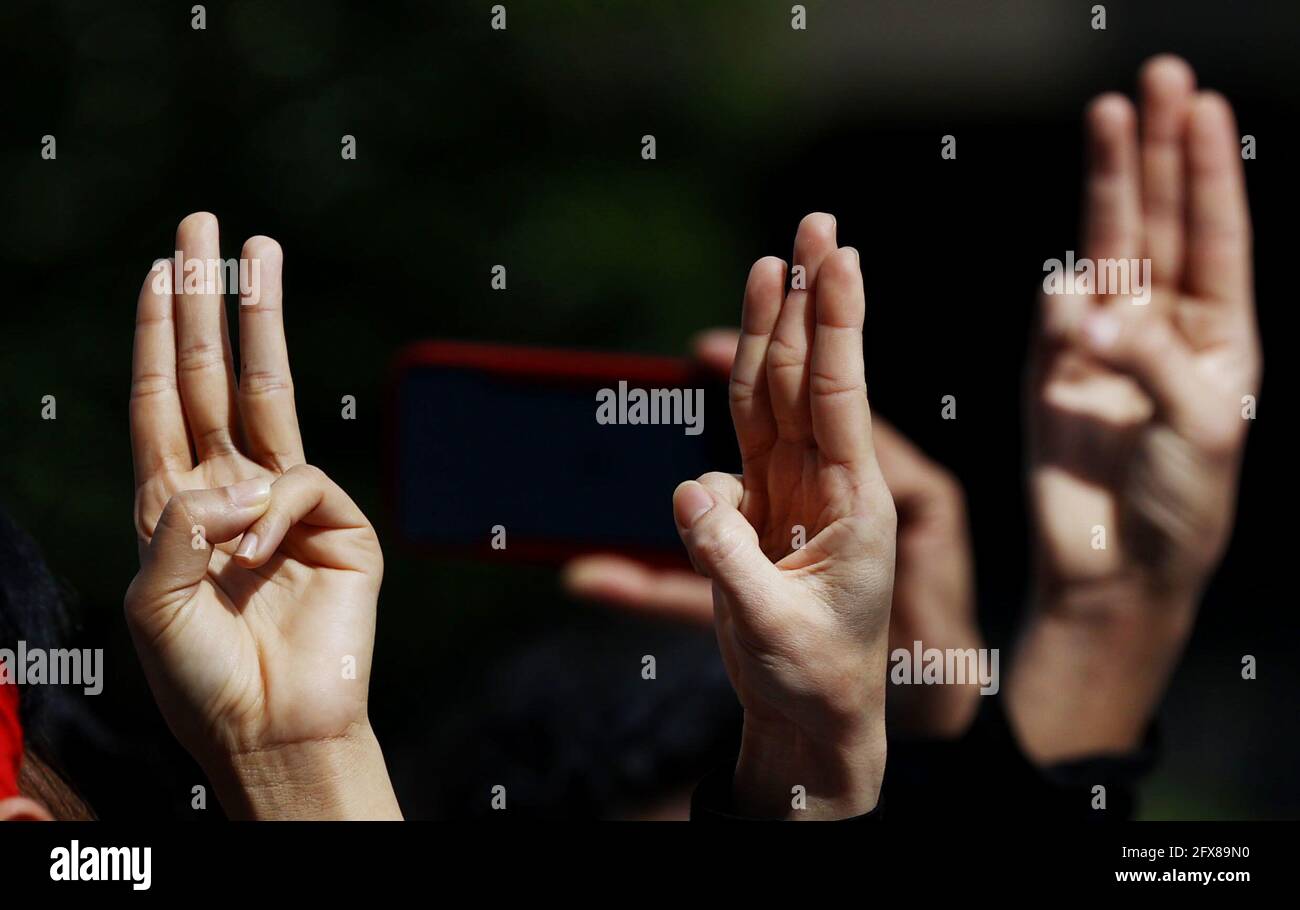 Myanmar residents in Japan show three-finger salutes, a symbol of ...