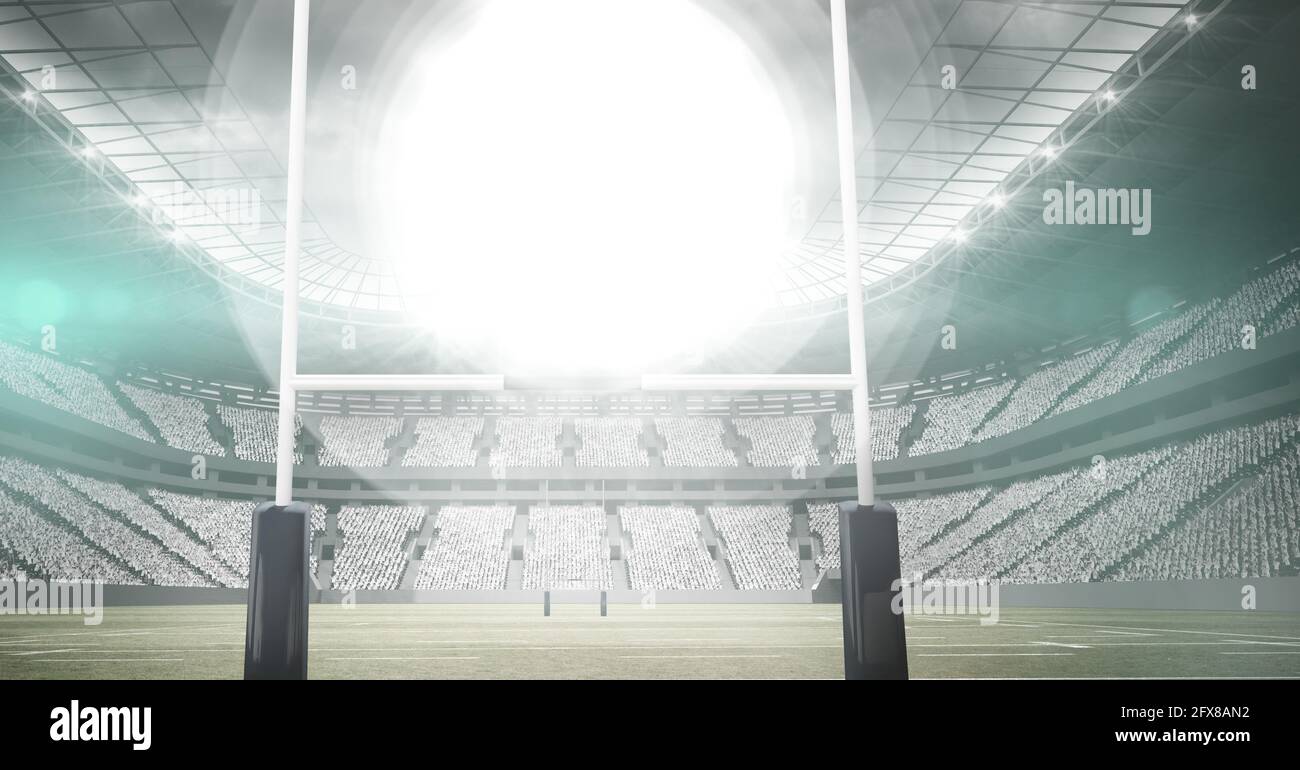 Composition of rugby ball and empty sports stadium with glowing ...