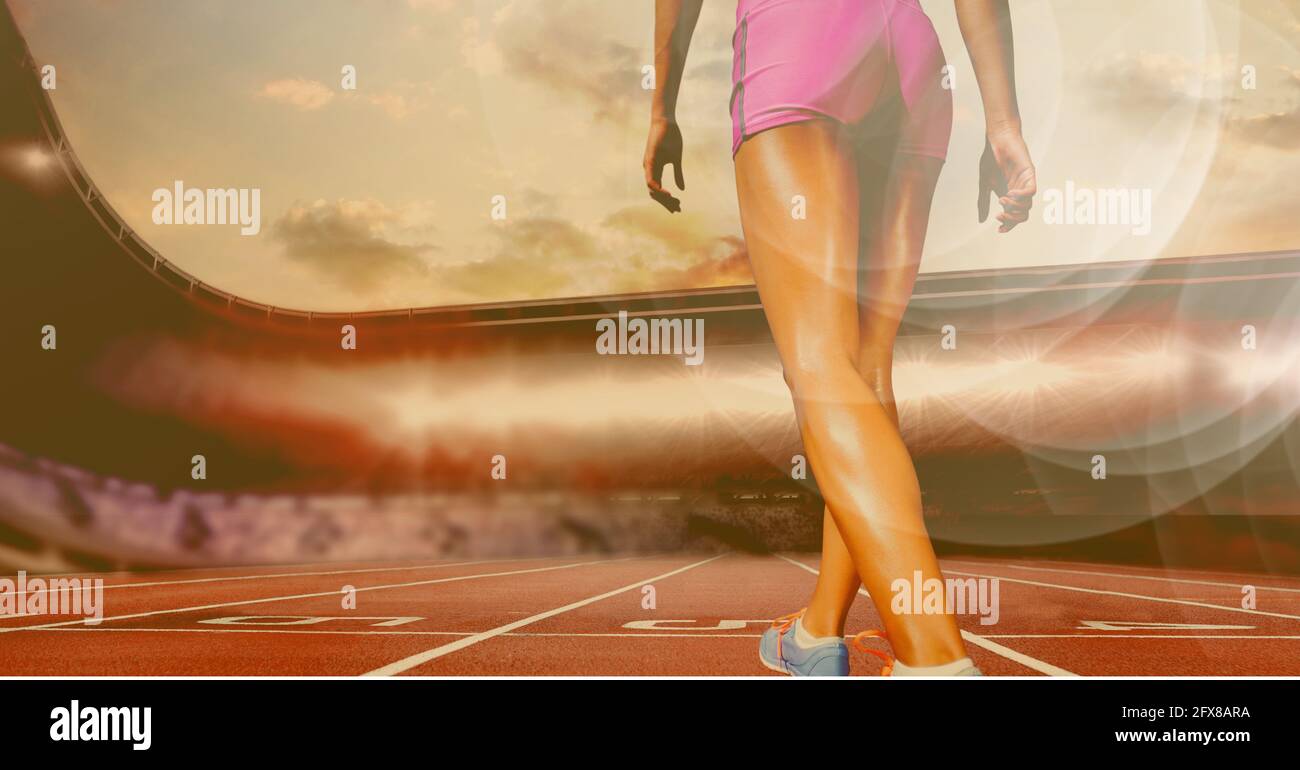 Composition of legs of female runner on racing track with spots of ...