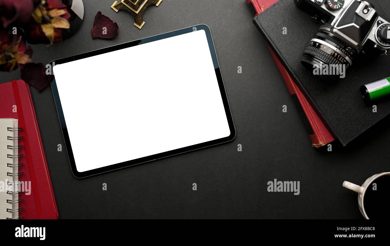 Top view of stylish flat lay workspace with digital tablet, camera and notebooks, clipping path ...