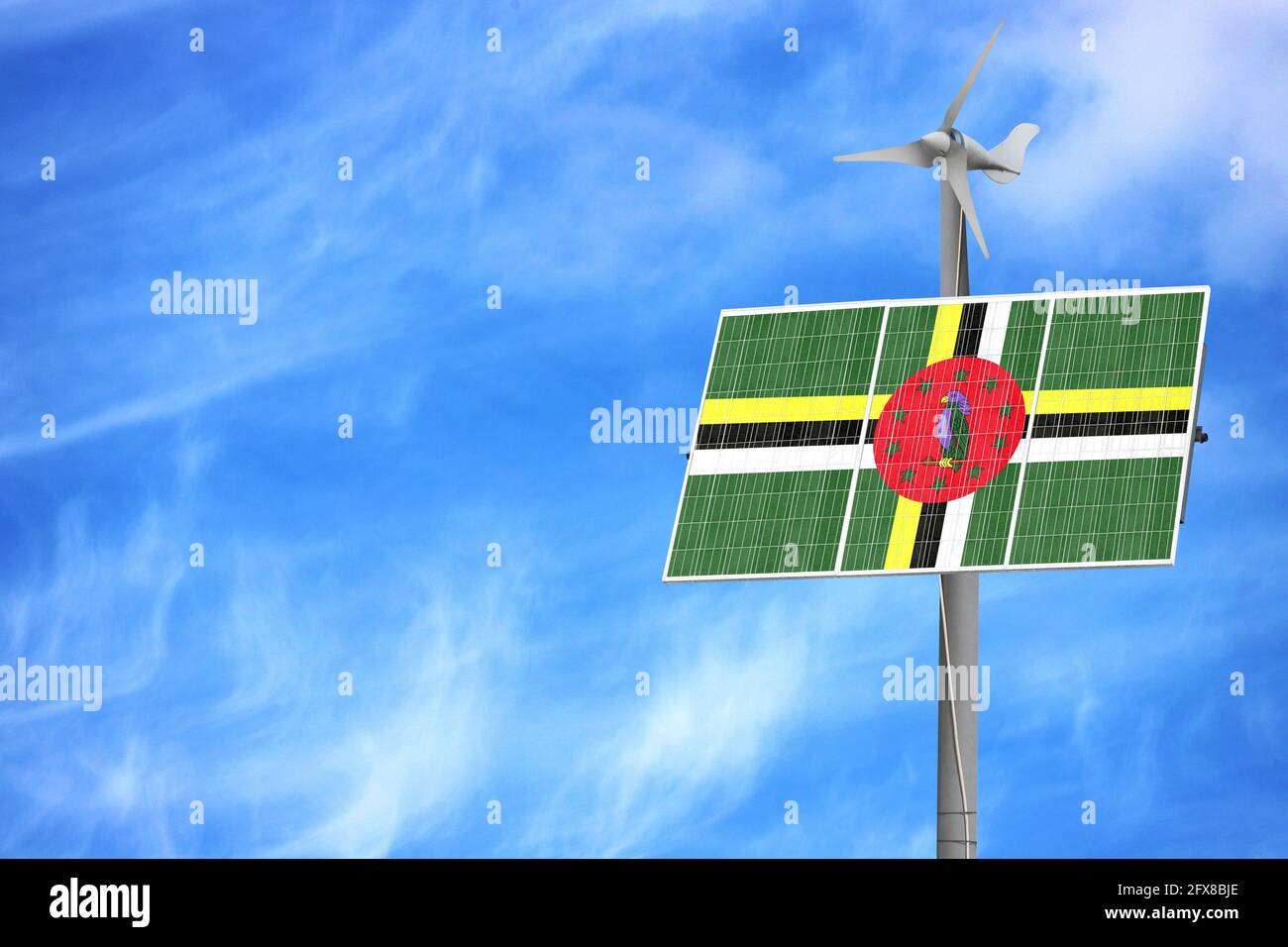 Solar panels against a blue sky with a picture of the flag of Dominica ...