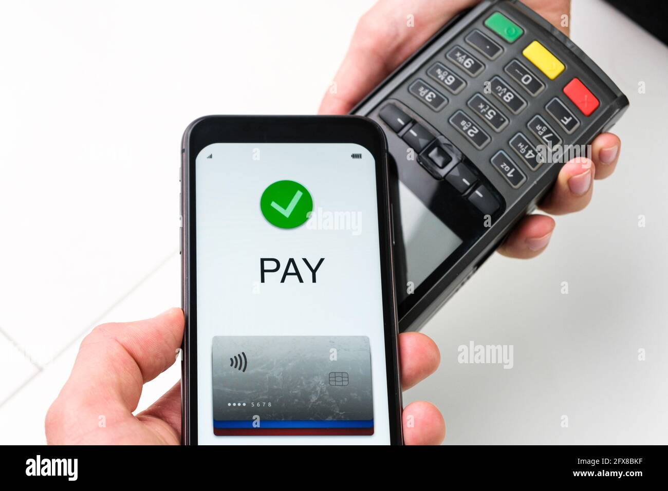 Customer paying bill using mobile phone application and POS terminal ...