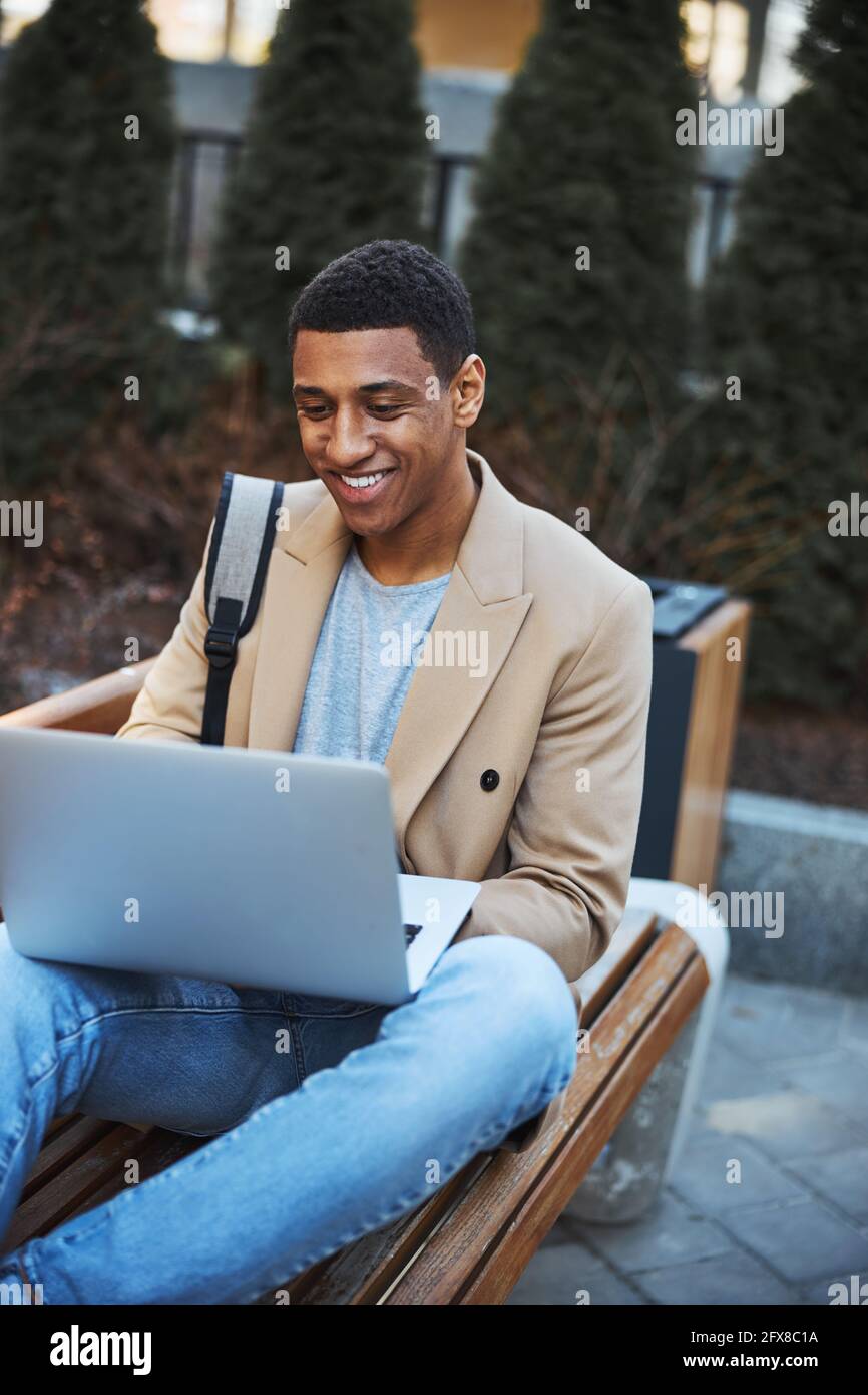 Joyful male person staring at screen of laptop Stock Photo - Alamy