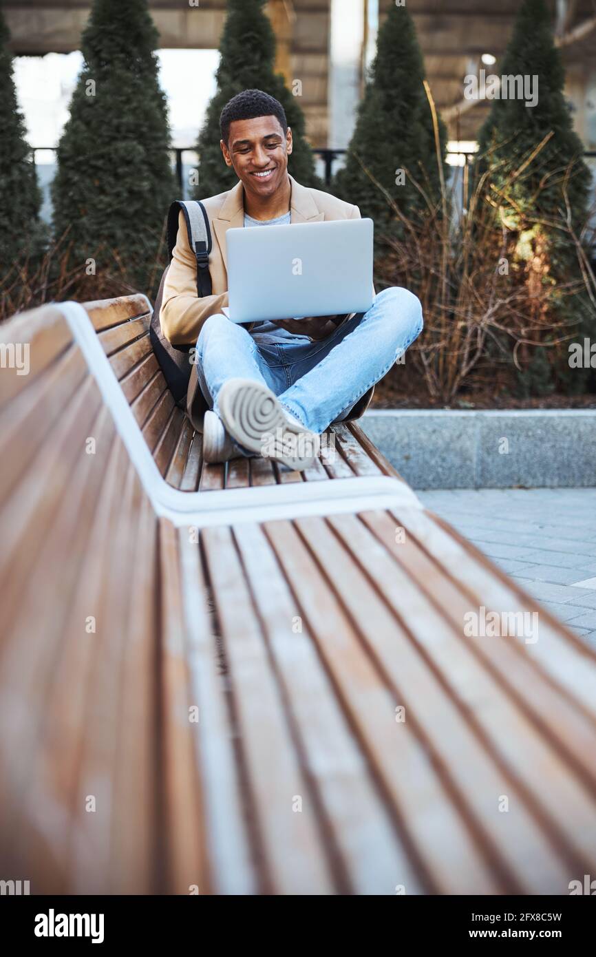 Kind young man having rest on the bench Stock Photo - Alamy