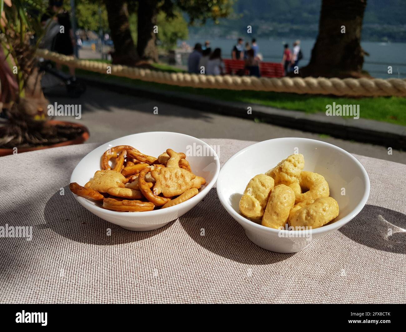 Closeup of small bowls with salty snacks Stock Photo - Alamy