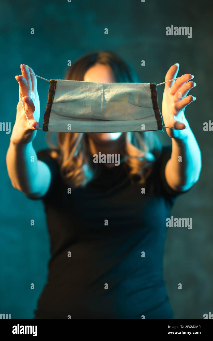 Woman with hidden face shows medical mask. Self-isolation and virus ...
