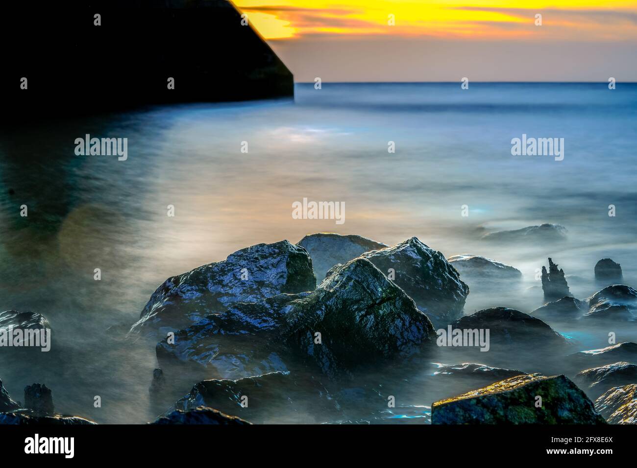 Rocky coast of sea. Slow shutter speed for smooth water level and ...