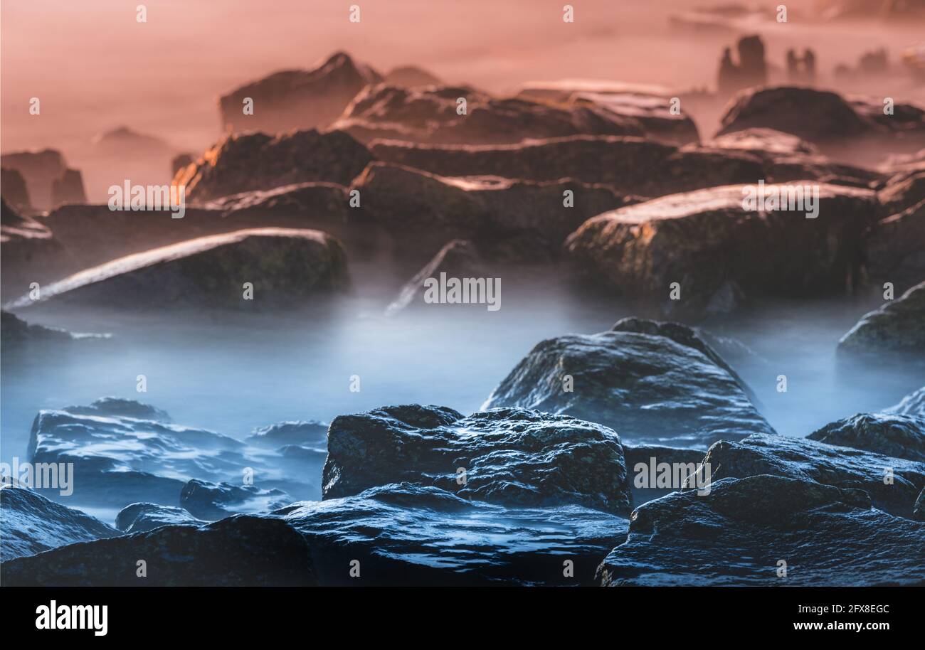 Rocky coast of sea. Slow shutter speed for smooth water level and ...