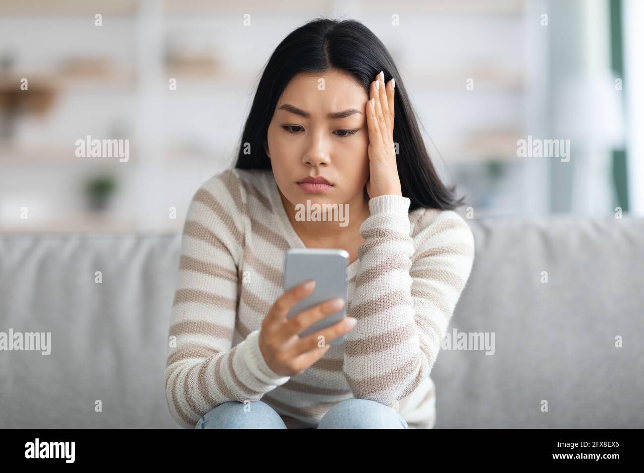Bad News. Upset Asian Female Holding Smartphone, Looking At Screen With ...