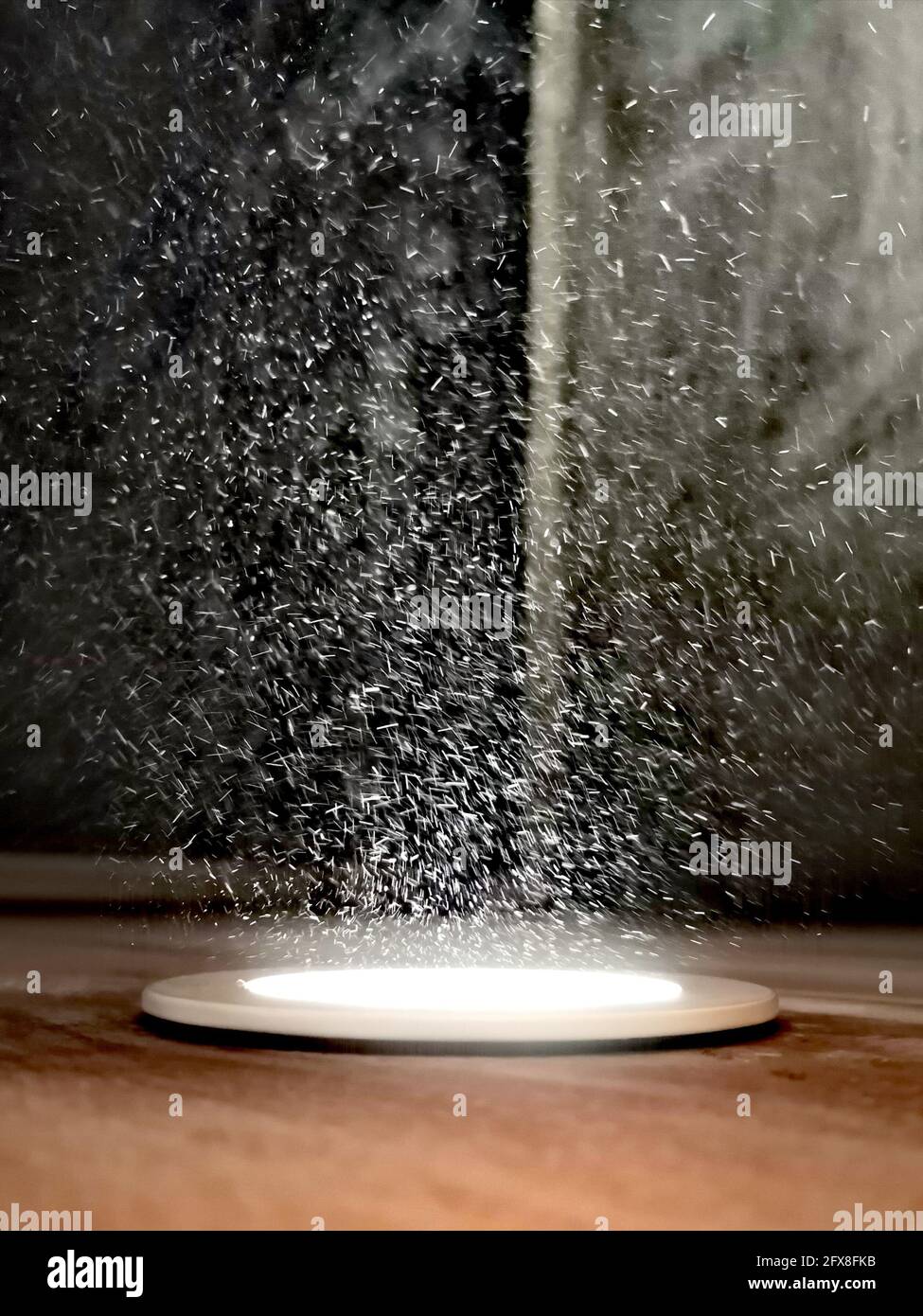 Vertical shot of moving dust particles in a light ray Stock Photo - Alamy
