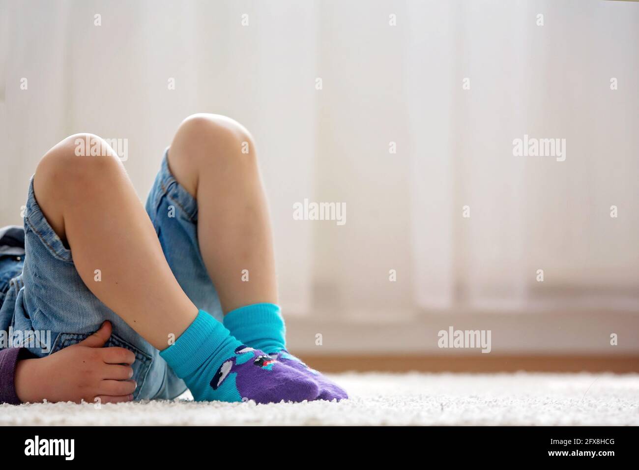 Child feet with different socks standing in rows, kids wearing ...