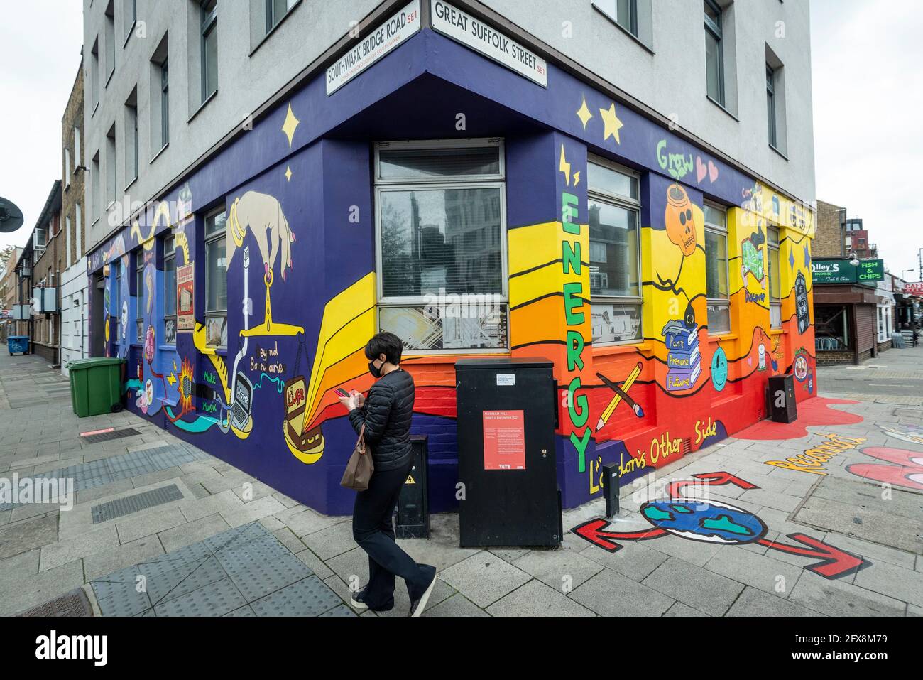 London, UK. 26 May 2021. A woman walks past artist Hannah Hill's work ...
