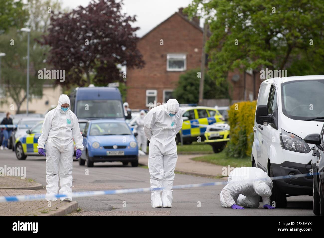 Police and forensic officers at the scene in Constable Road, Corby ...
