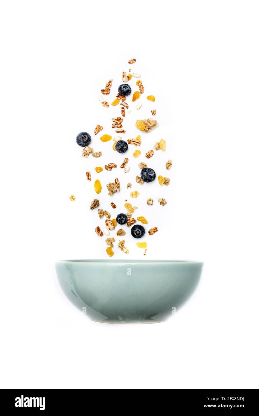 Flakes of cereal falling into a bowl Cut Out Stock Images & Pictures ...