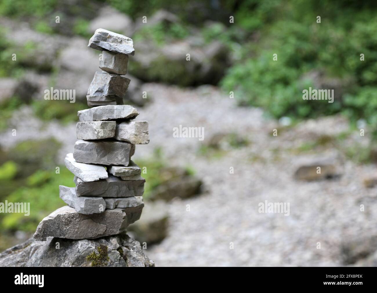 High stack of rocks in the mountains called by CAIRN climbers or small ...