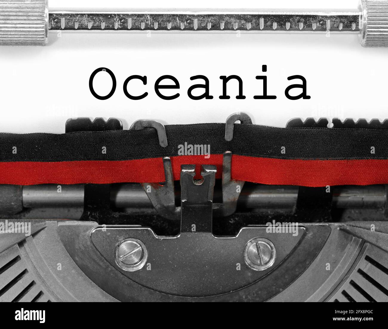 Oceania text writen with a vintage typewriter on white paper with black ...