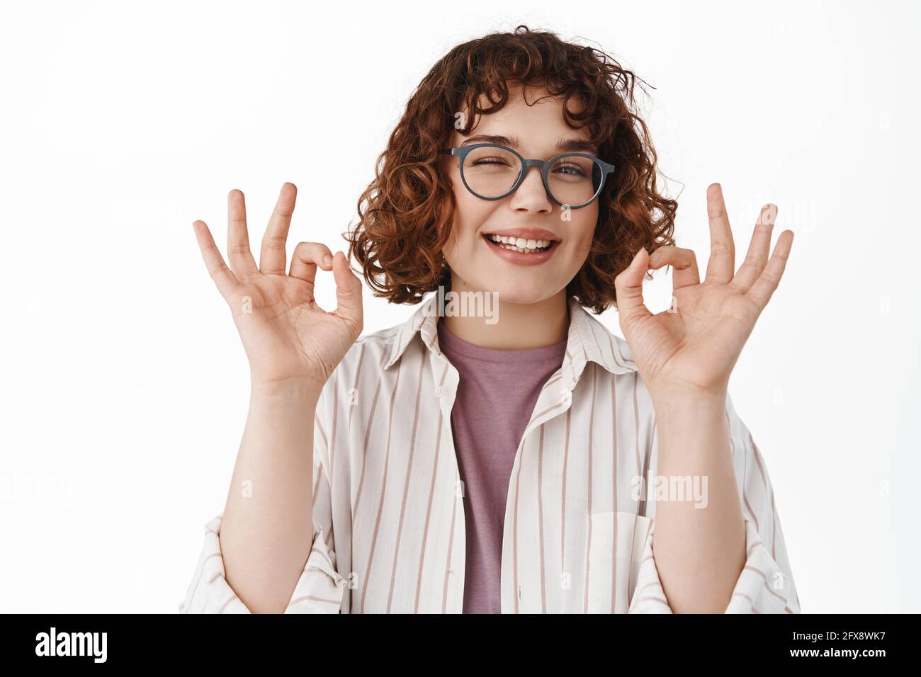 Stylish young woman praise something good, showing okay signs OK and ...