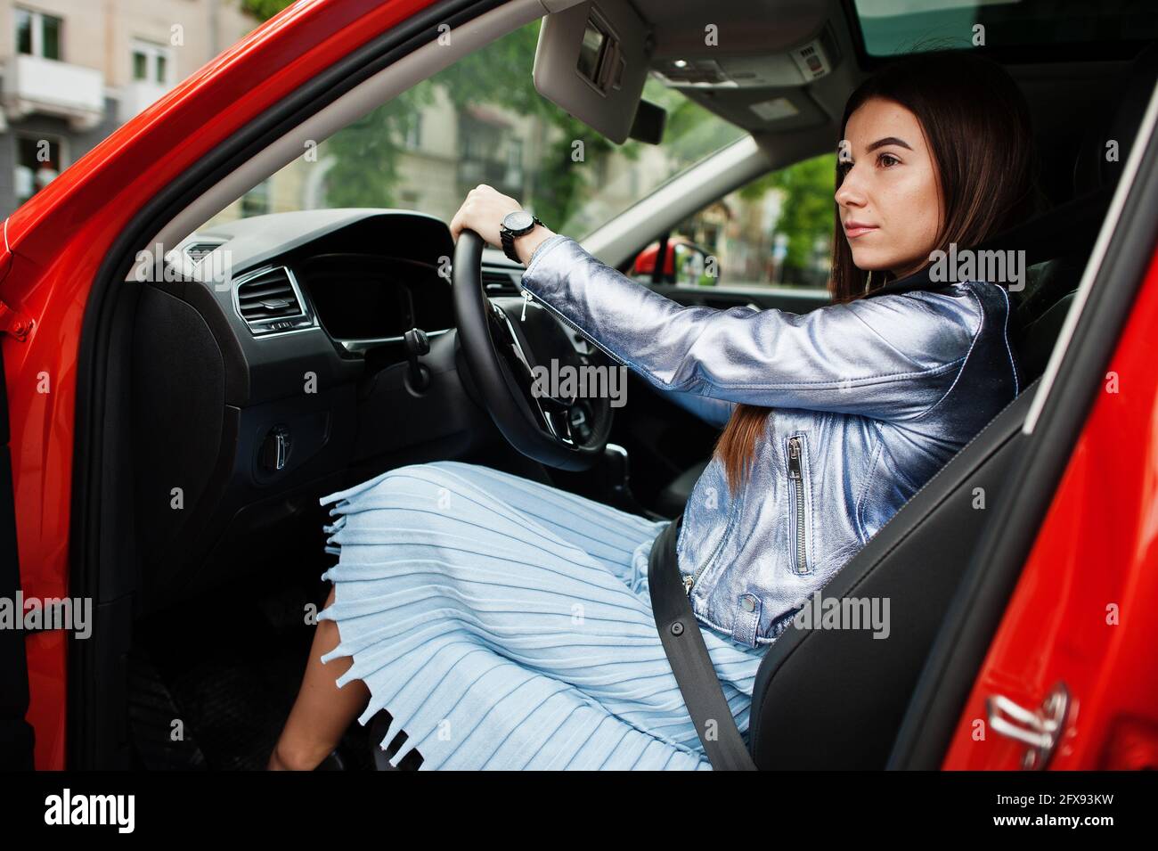 Gorgeous woman sitting inside car with open door Stock Photo - Alamy