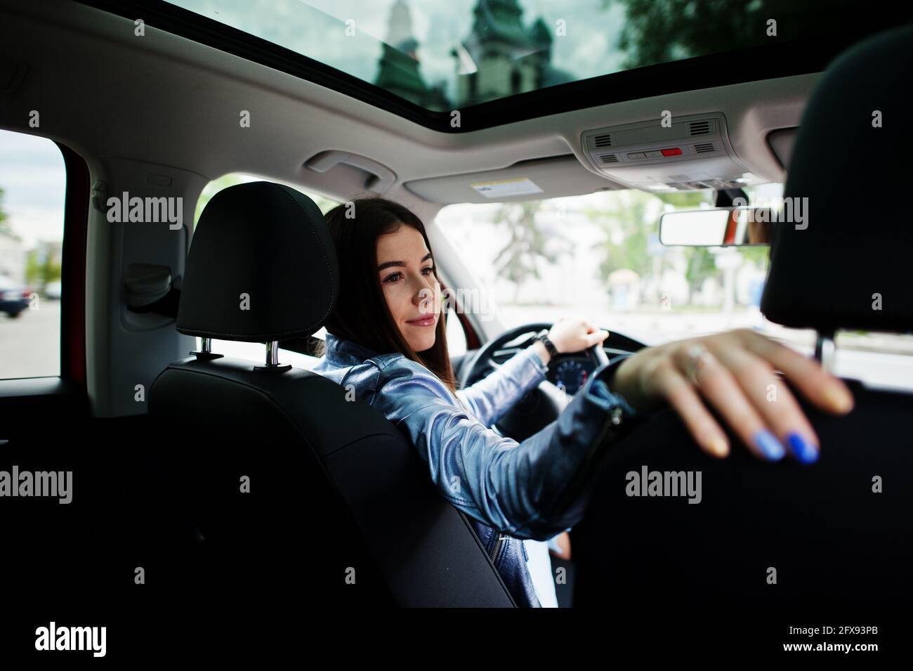 Gorgeous woman sitting inside car interior Stock Photo - Alamy