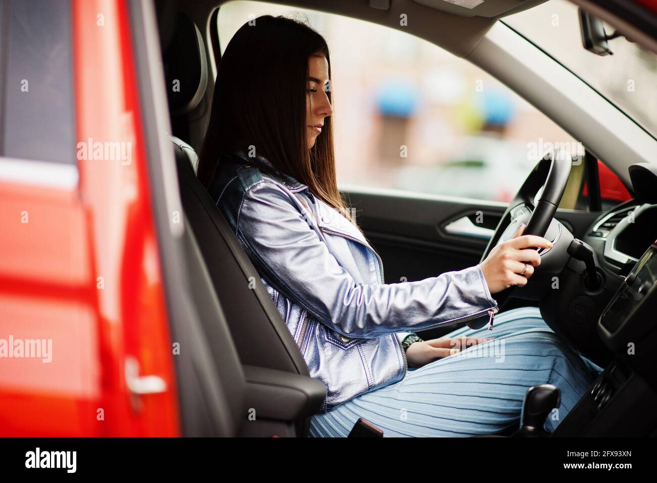 Gorgeous woman sitting inside car interior Stock Photo - Alamy