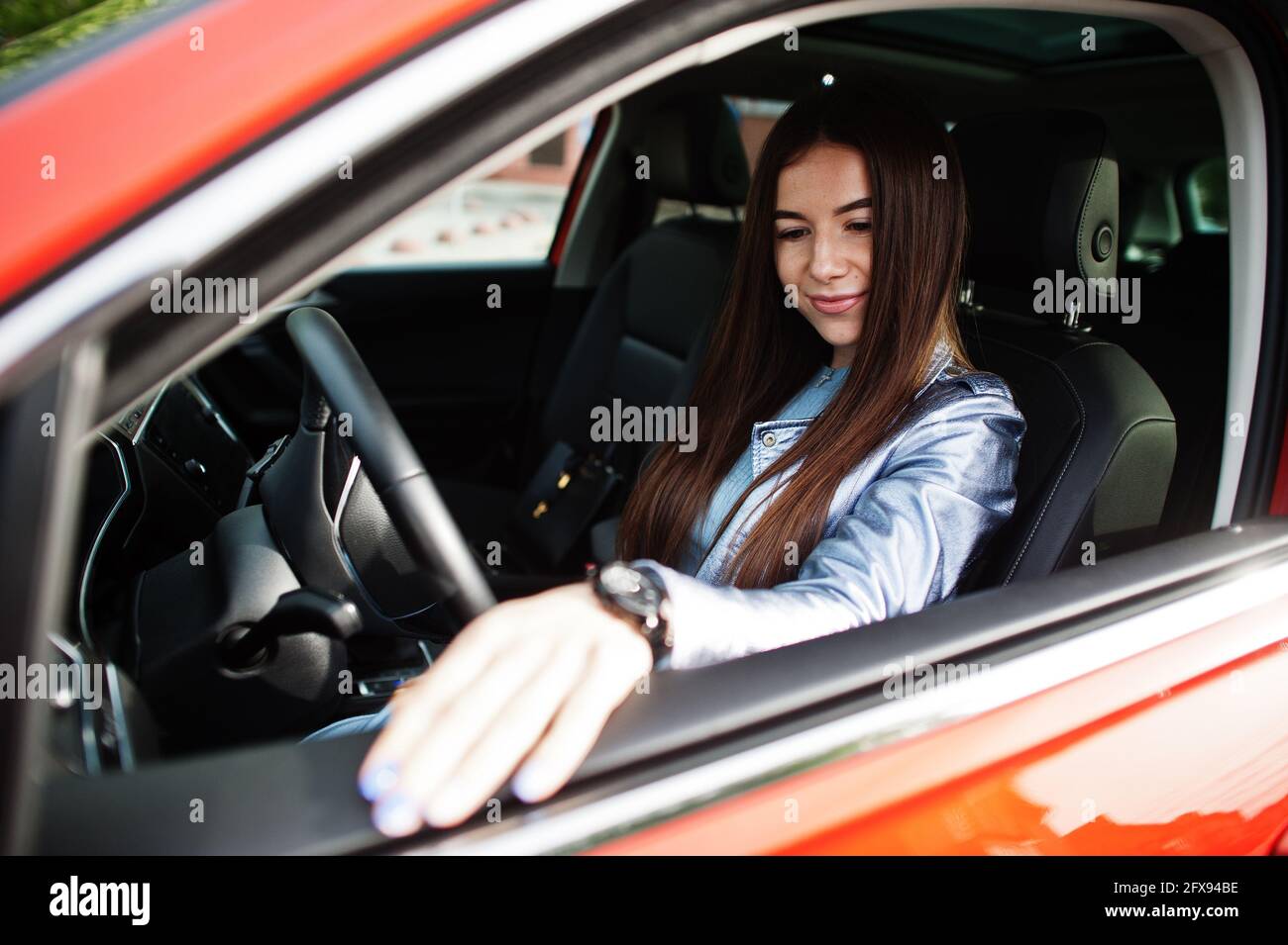 Gorgeous woman sitting inside car interior Stock Photo - Alamy