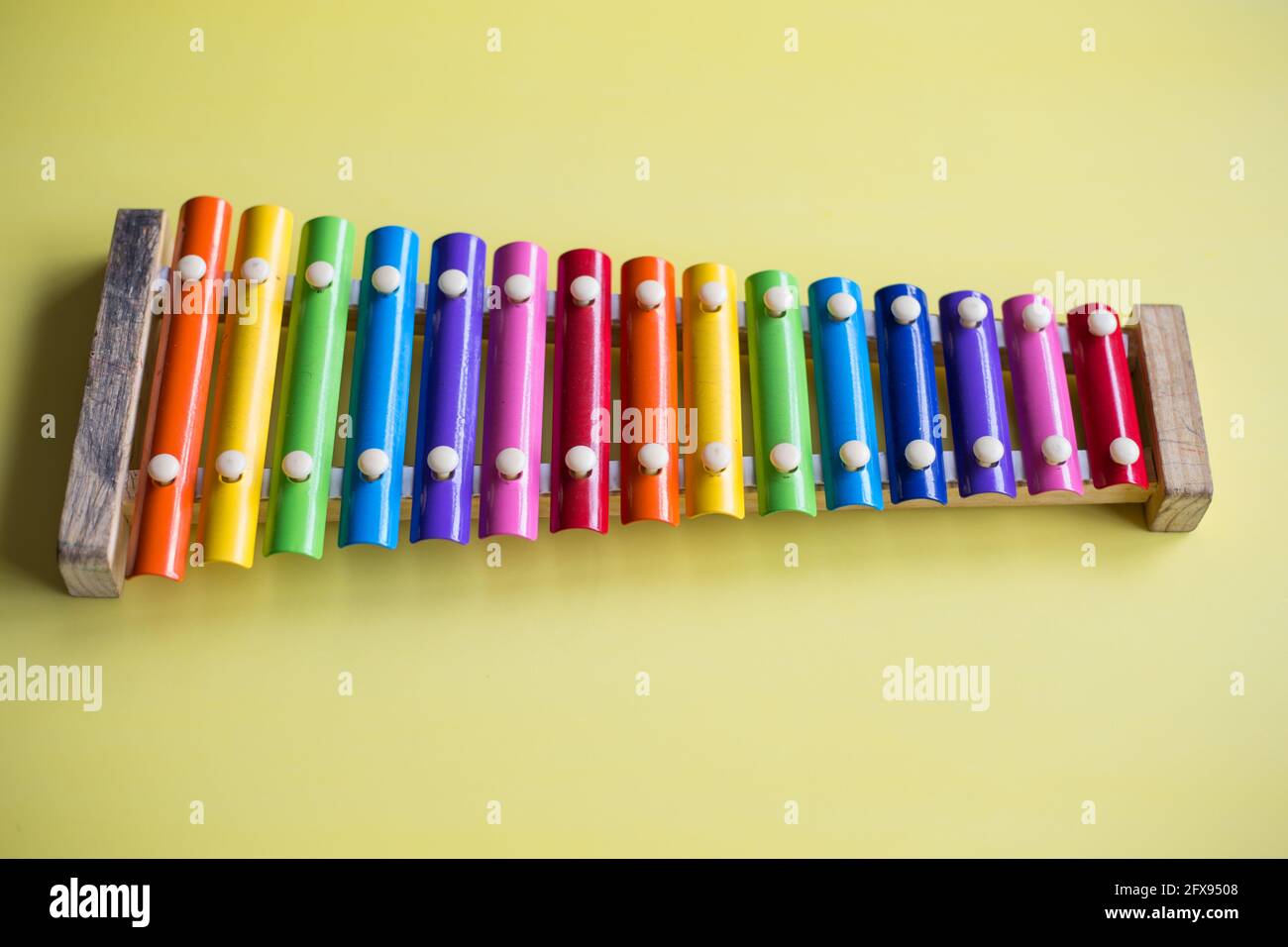 Overhead shot of toy xylophones music equipment on a yellow surface ...