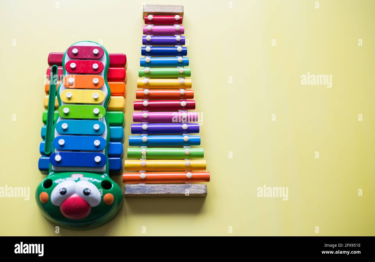 Overhead shot of toy xylophones music equipment on a yellow surface ...