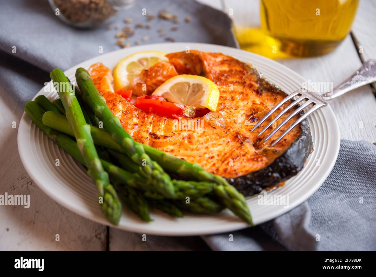 Salmon stake cooked with lemon and asparagus Stock Photo - Alamy