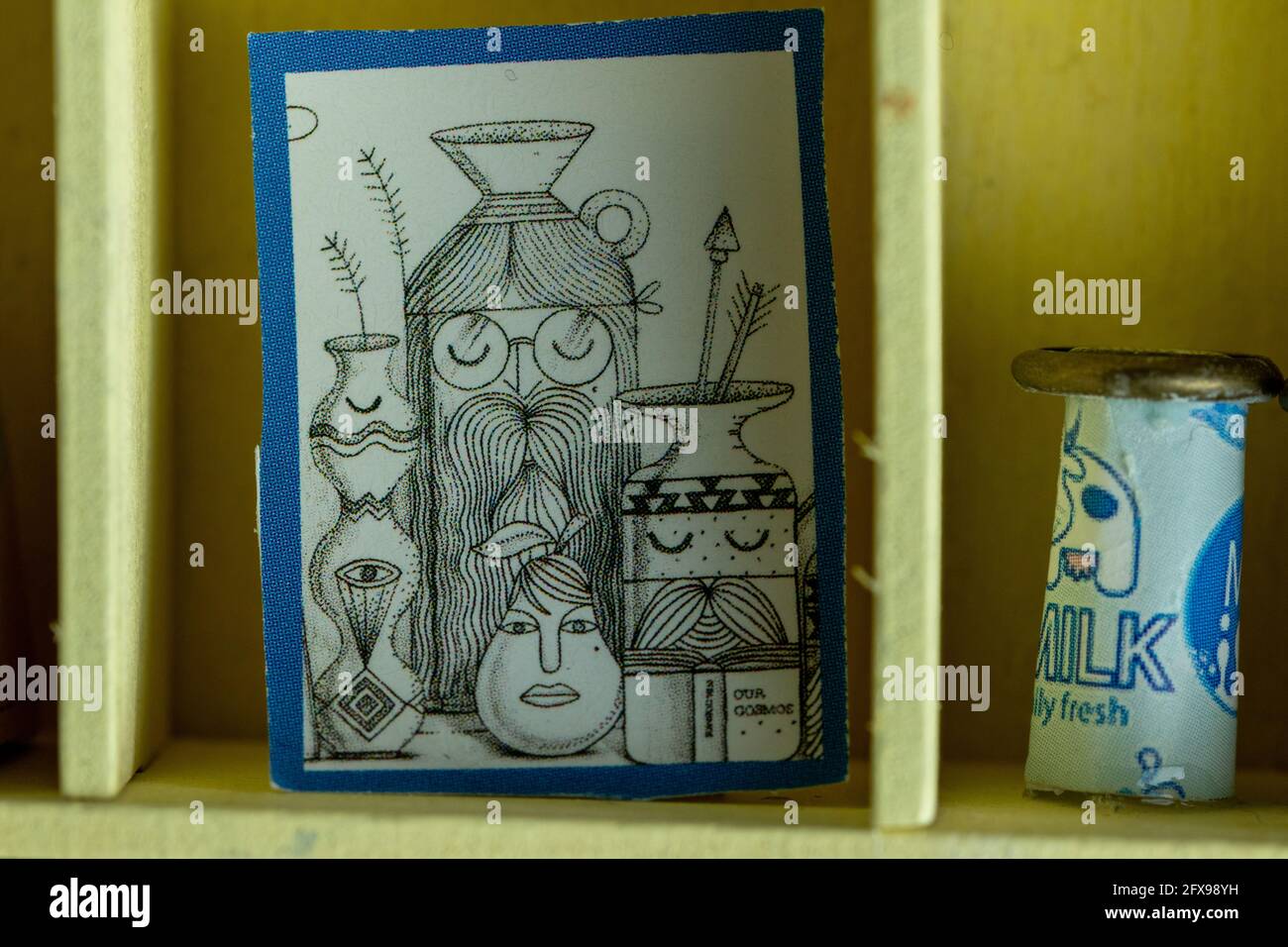 Closeup view of a surrealistic drawing of objects with human faces ...