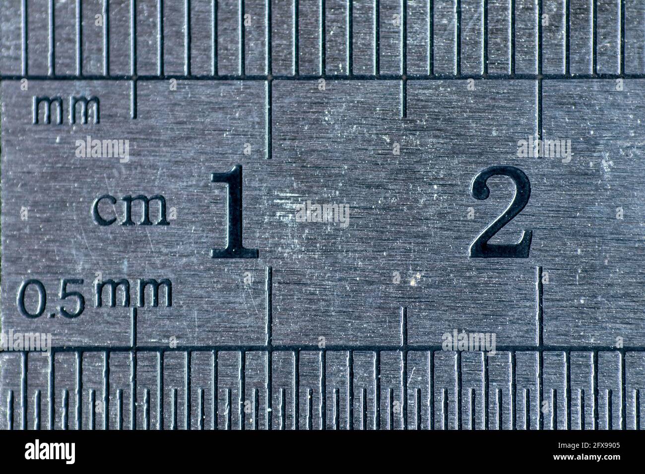 Closeup view of the numbers one and two on the old metallic ruler Stock ...