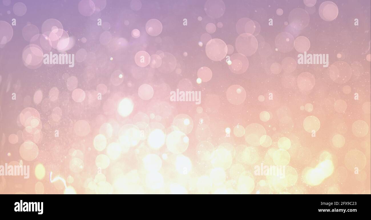 Composition of softly glowing, floating particles with yellow and pink ...