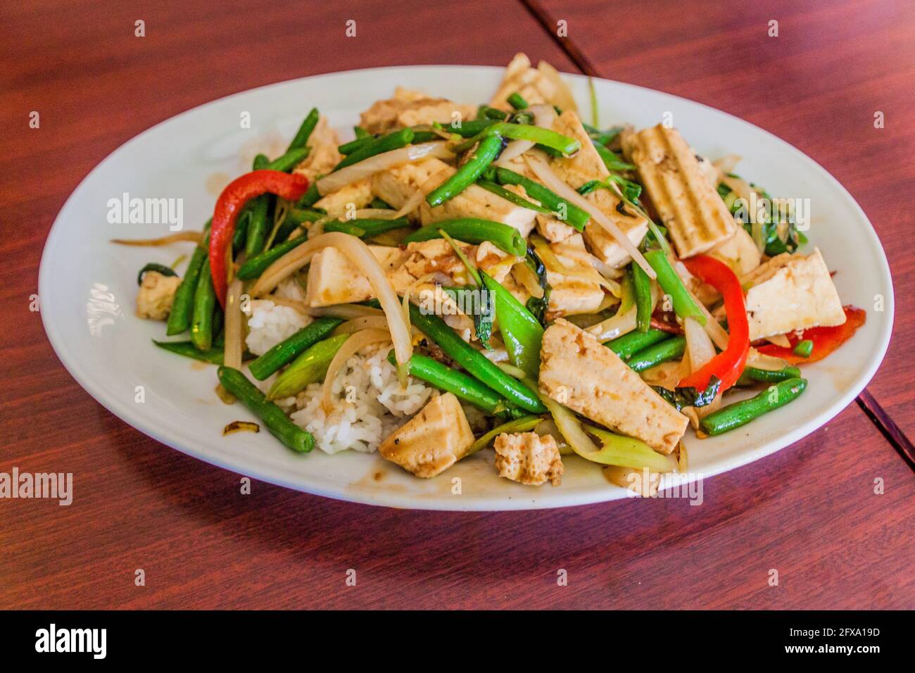 Plate of a Thai meal. Rice, tofu and vegetables Stock Photo - Alamy