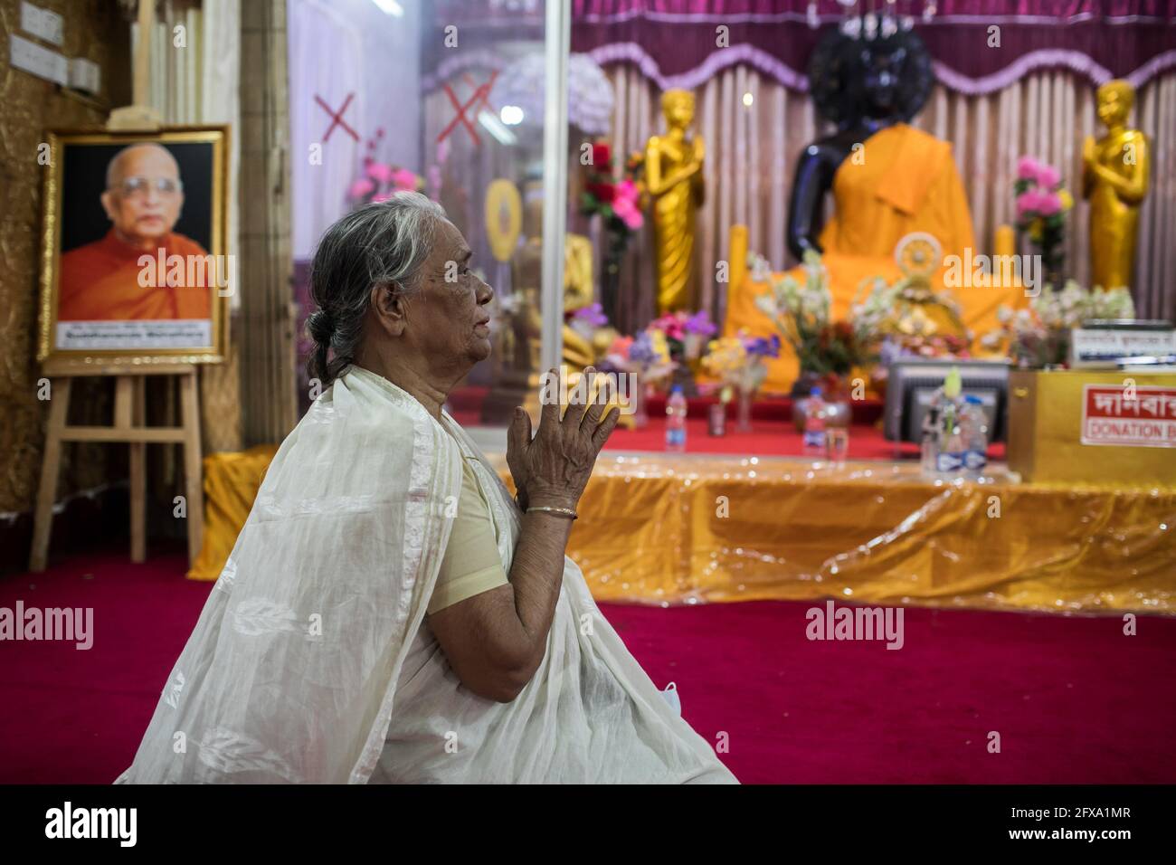 Buddhist devotee seen praying at a temple during the celebrations ...